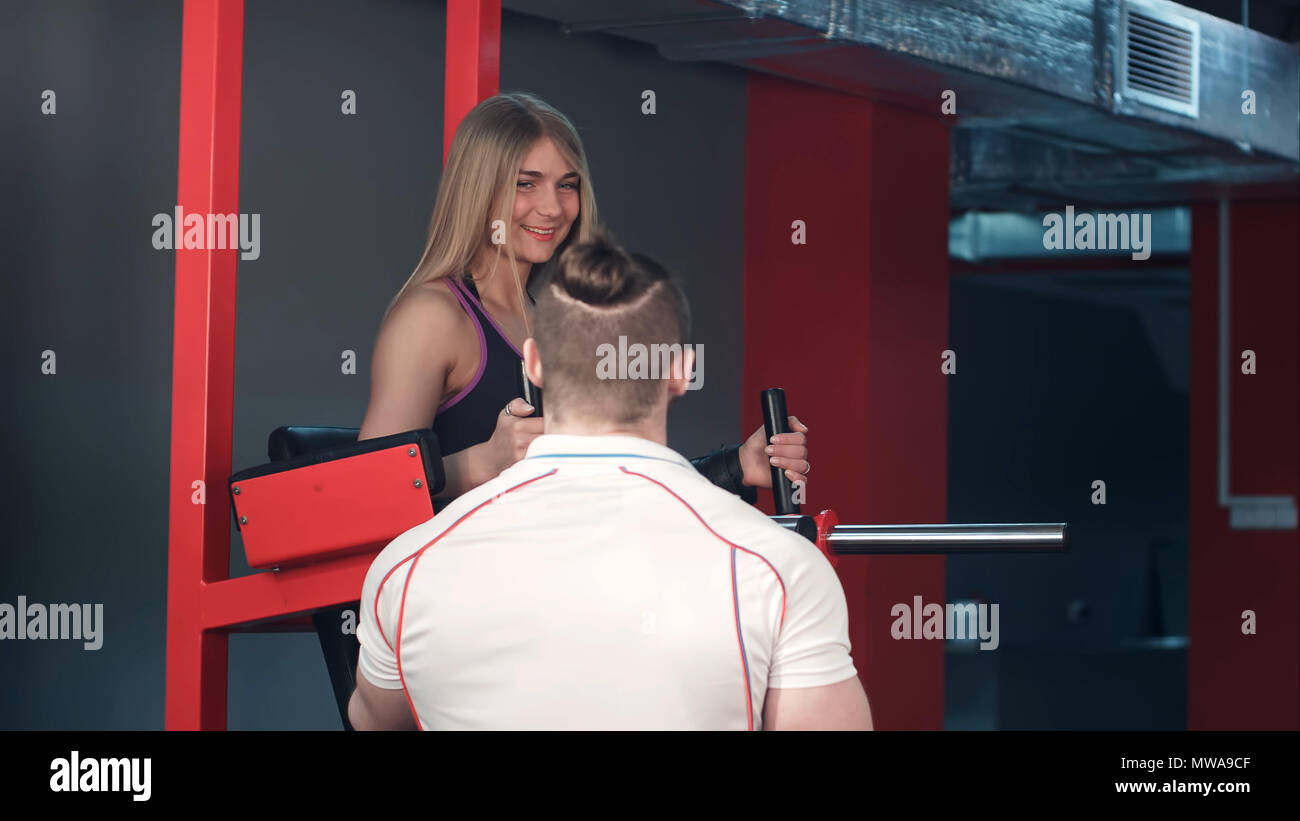 Personal trainer working with female client in the gym Stock Photo - Alamy