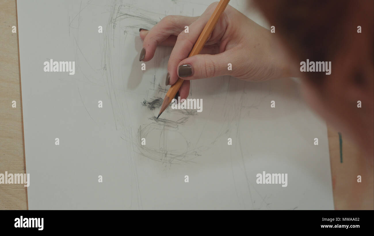 Woman's hand drawing classical man face with pencil Stock Photo - Alamy