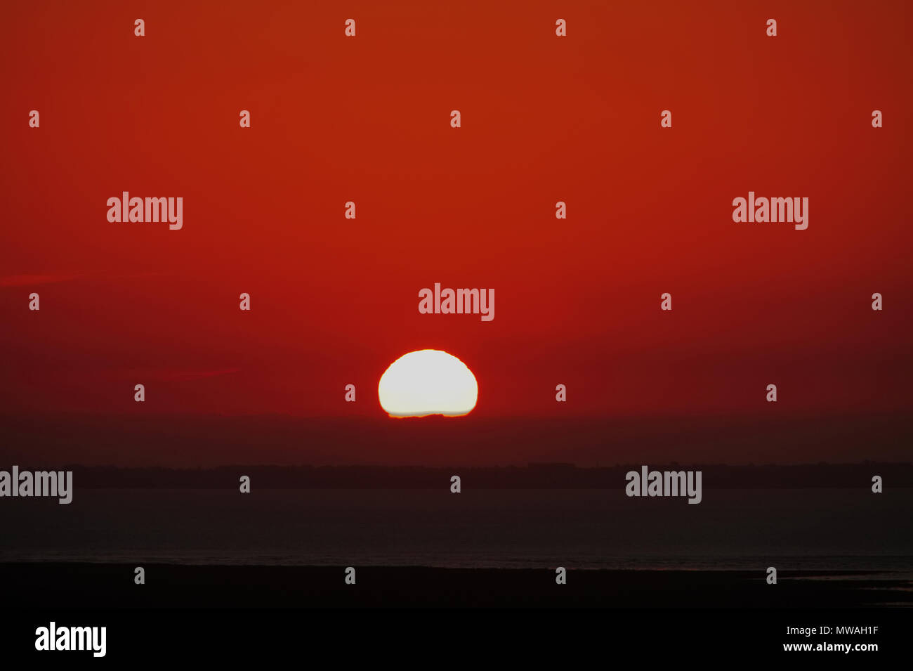 Sunset over water Stock Photo - Alamy