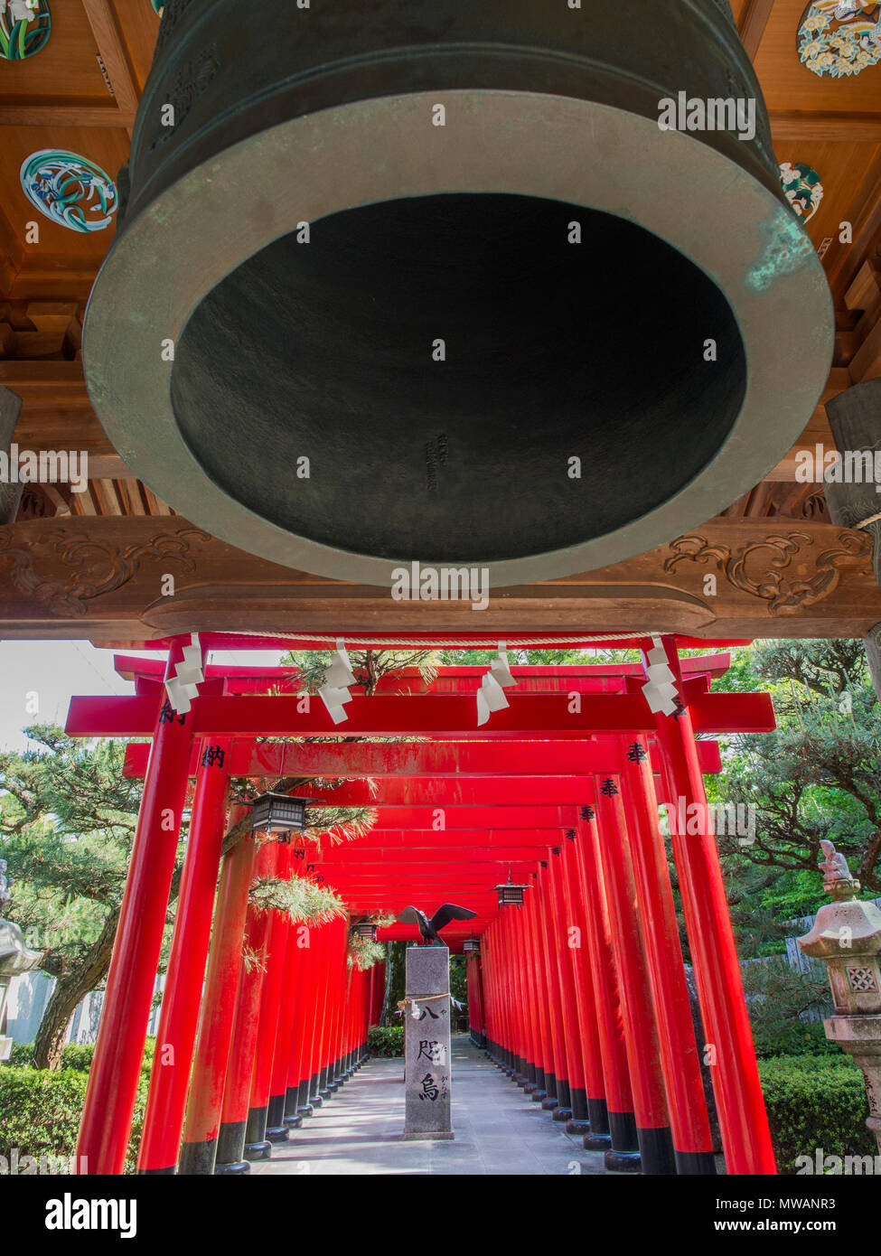 Shinto environment.Bronze bell at entrance to Tamura shrine, leading to ...