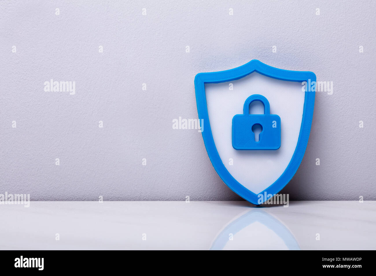 Blue Shield Security Icon Against White Wall Stock Photo - Alamy