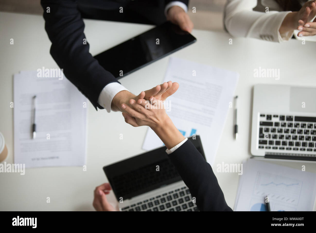 Colleagues giving high-five celebrating good teamwork result, to Stock ...
