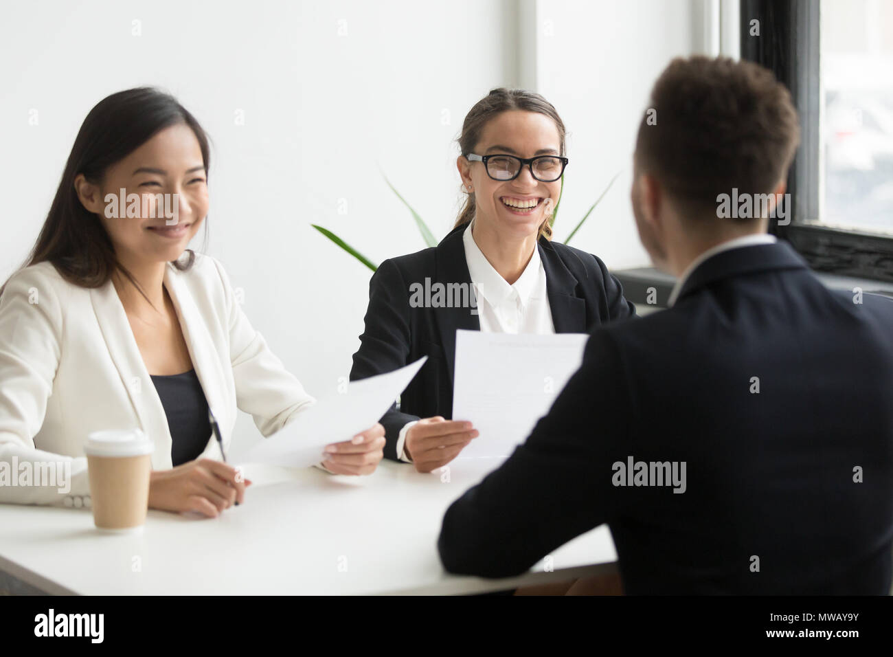 Positive hr executives laughing at job interview with successful Stock ...