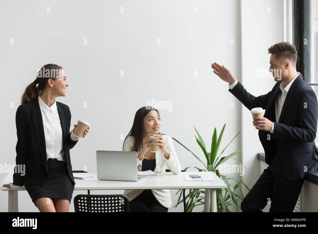 Office workers talking during coffee hi-res stock photography and ...