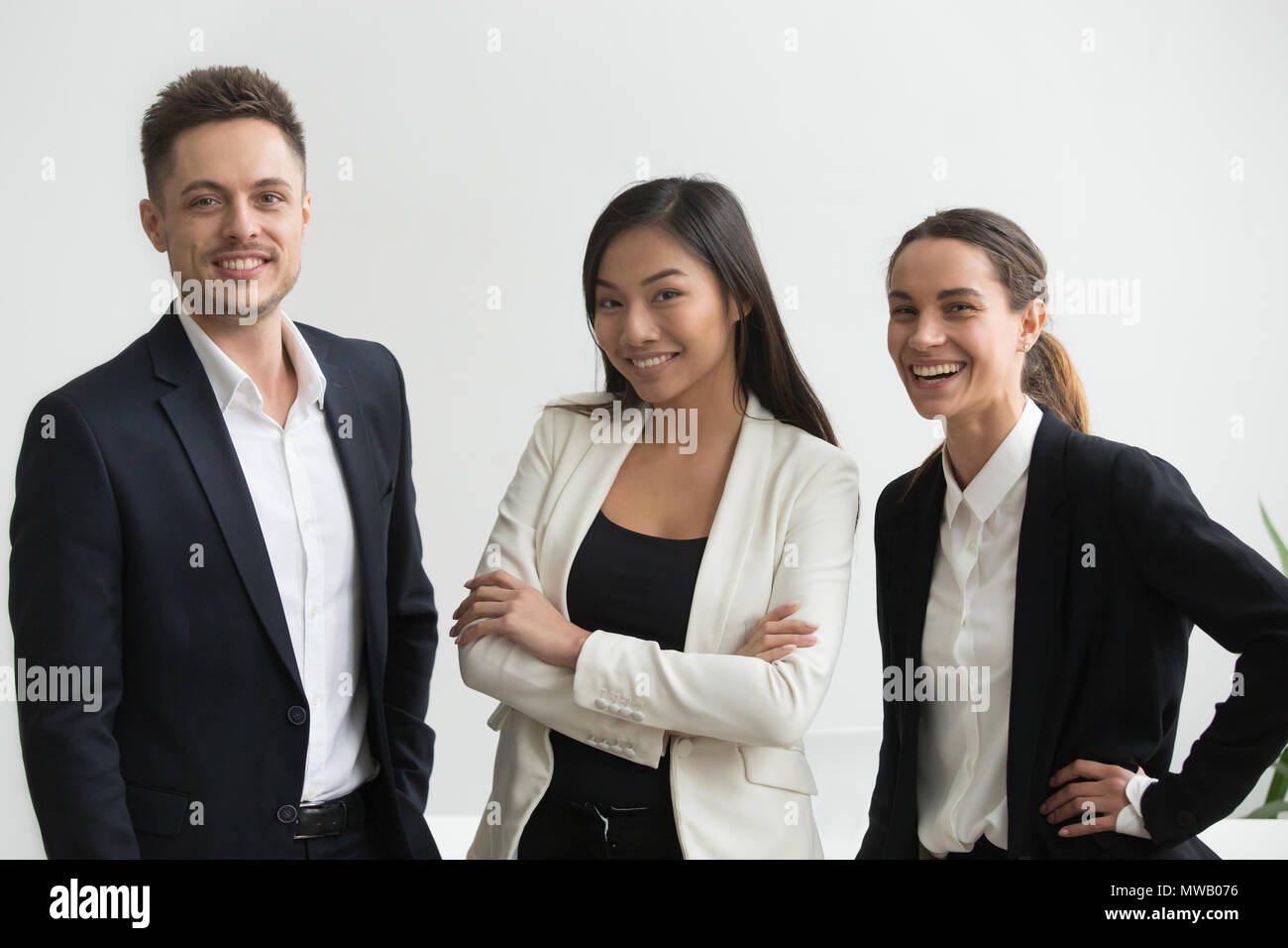 Millennial smiling multi-ethnic office professionals looking at Stock ...