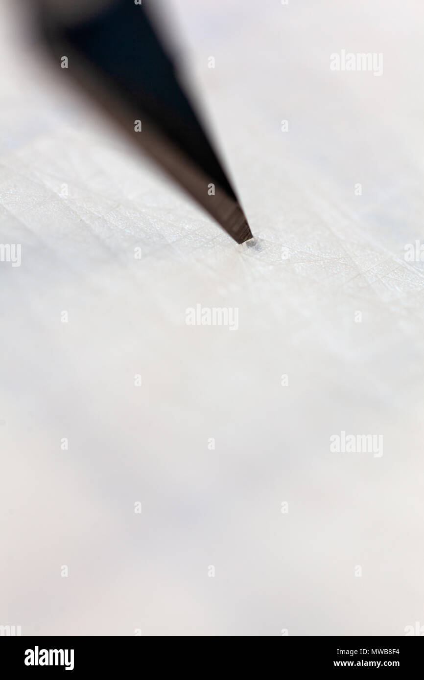 Fine knife point embedded in self-healing mat Stock Photo - Alamy