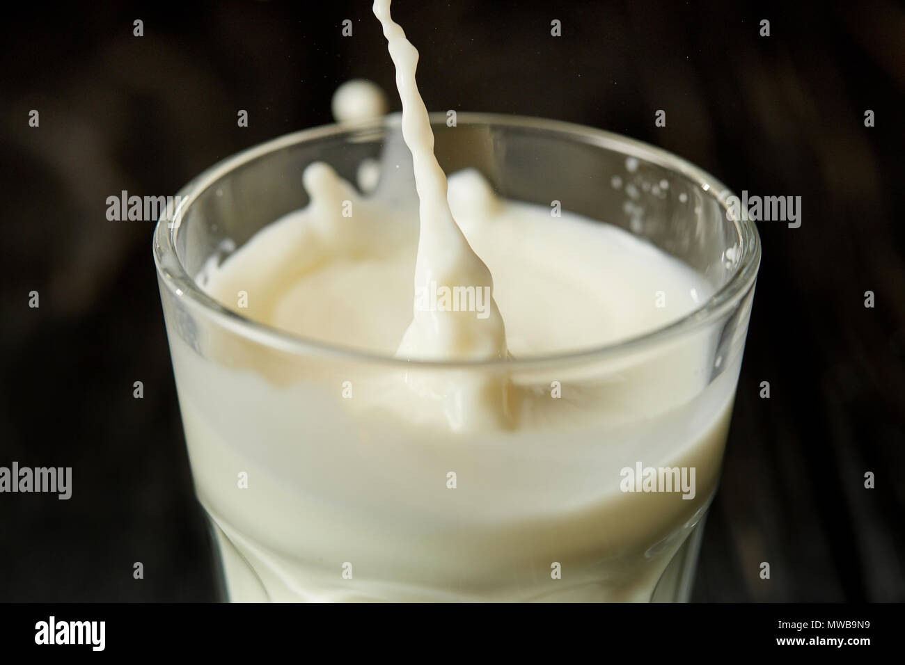 closeup view of splashing drops of milk from glass Stock Photo - Alamy