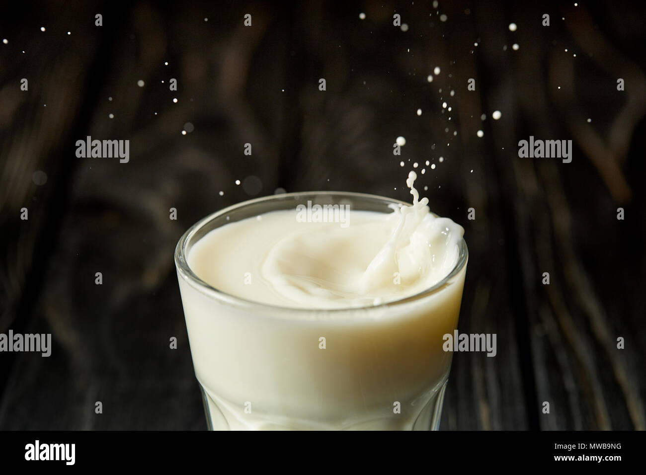 closeup view of splashing drops of milk from glass Stock Photo - Alamy