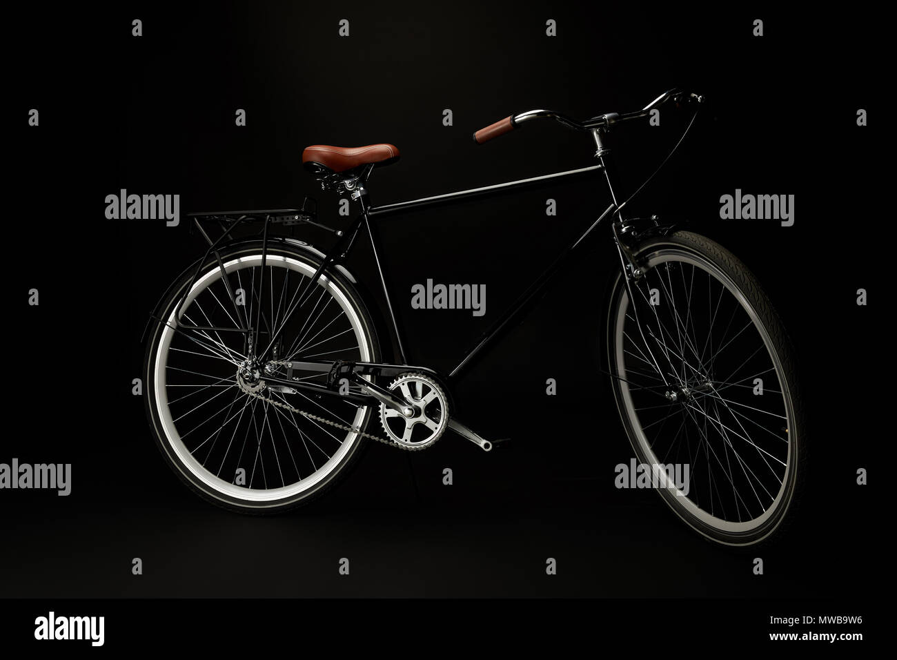 side view of comfortable vintage bicycle isolated on black Stock Photo ...