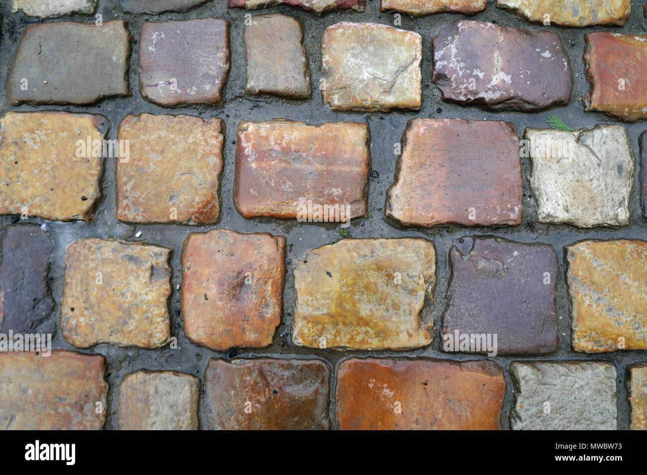 Stone pavement, stones of brown and yellow color of square form ...