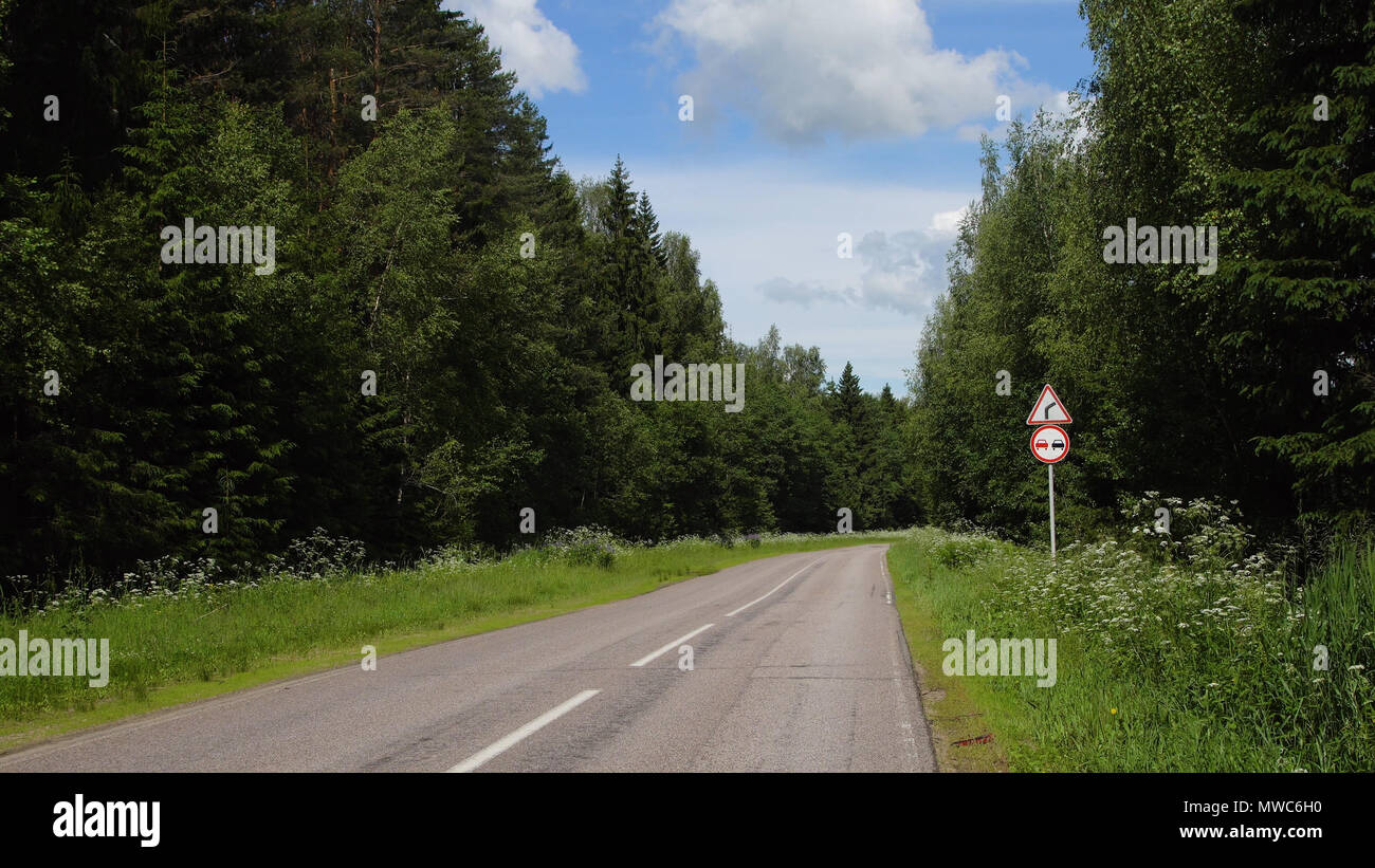 Road sign warning of dangerous right curve and sign no passing on the ...