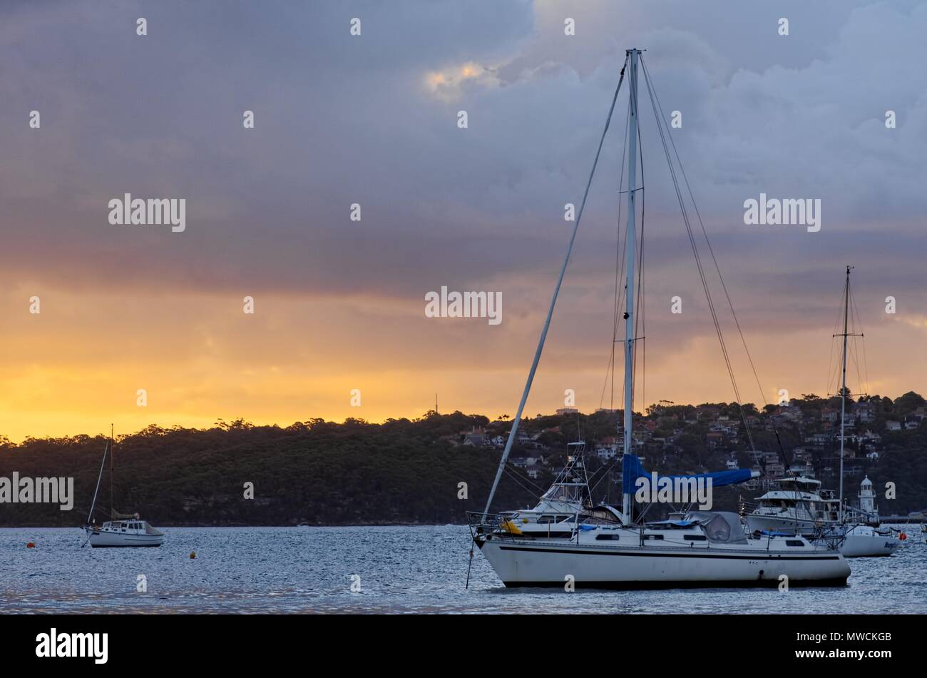 Boats on Sunset Bay Stock Photo - Alamy