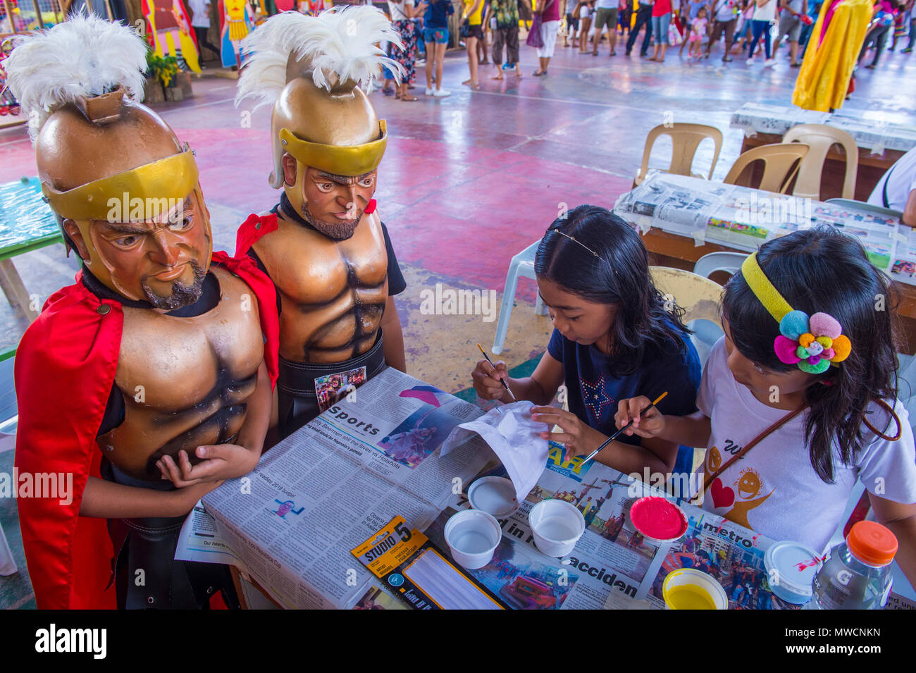 children decorating masks during the Moriones festival in Boac ...