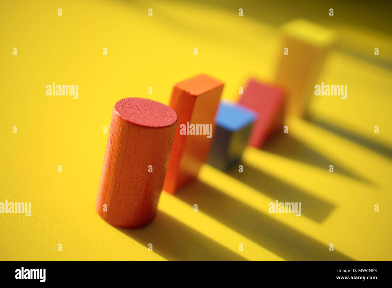 Wooden building blocks toy with shadow isolated on yellow background ...
