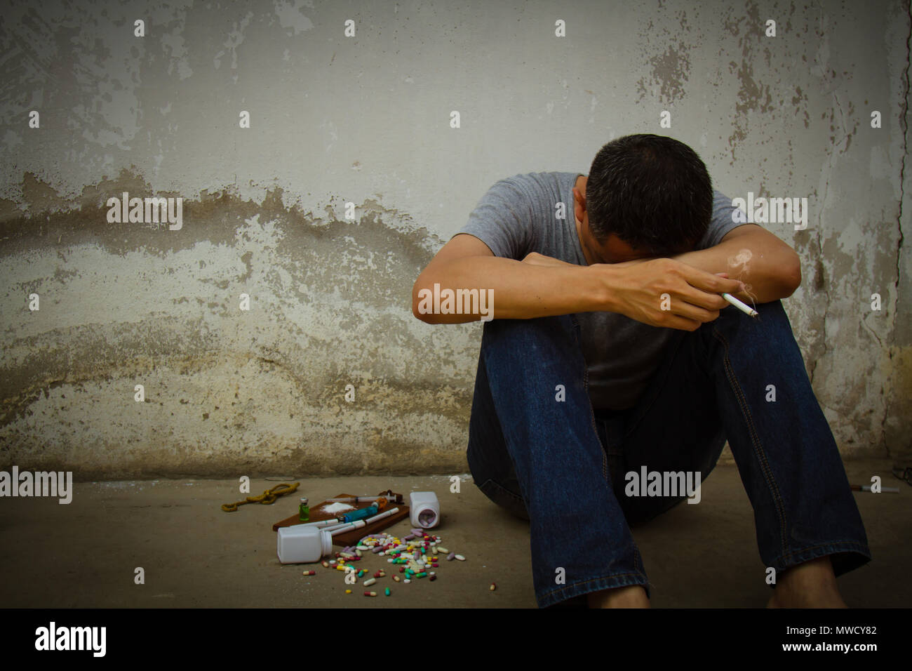 Asia man smoking cigarette is sad and pain by drug addiction problem ...