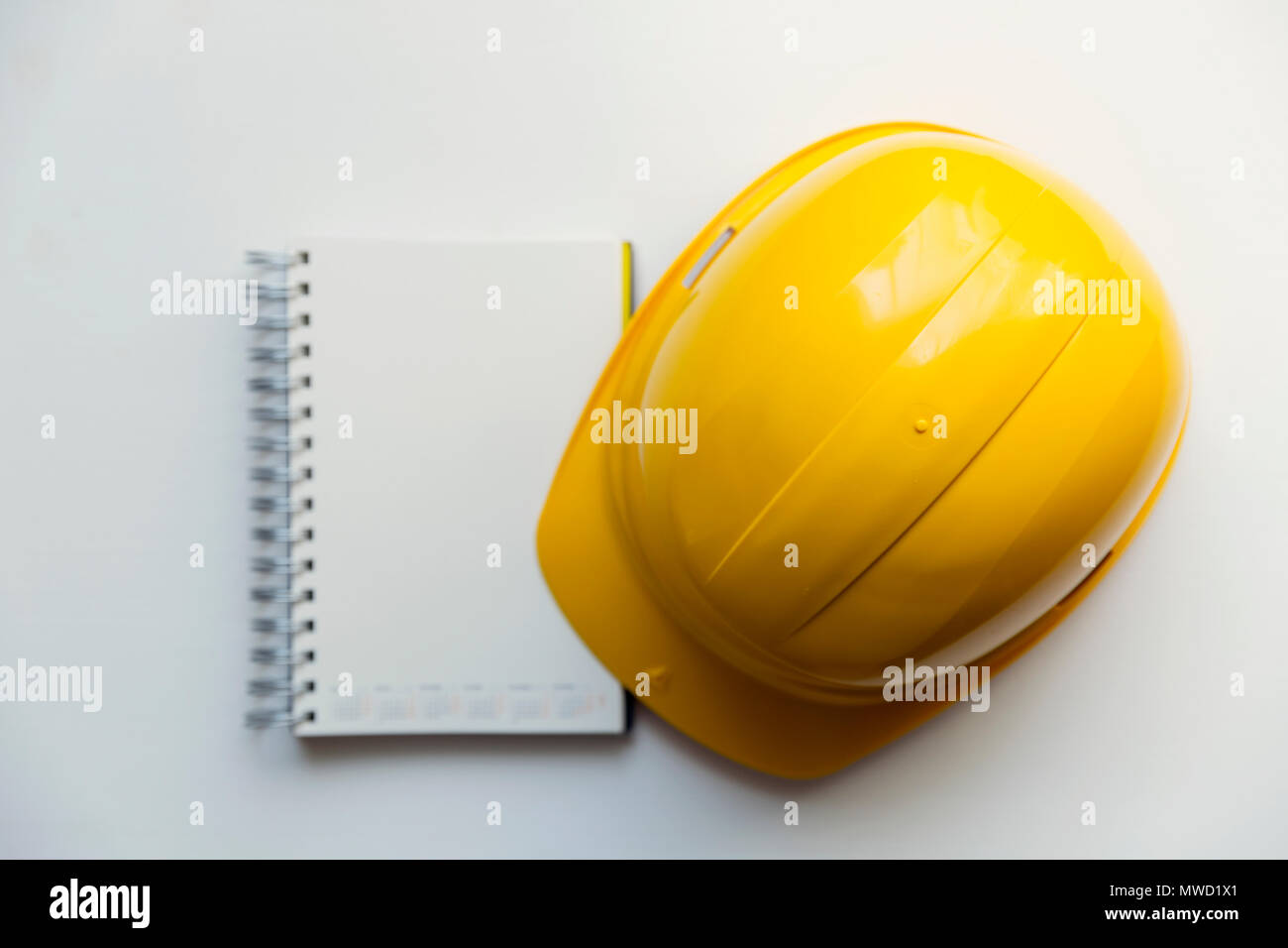 Yellow safety helmet and notebook isolated on white background ...