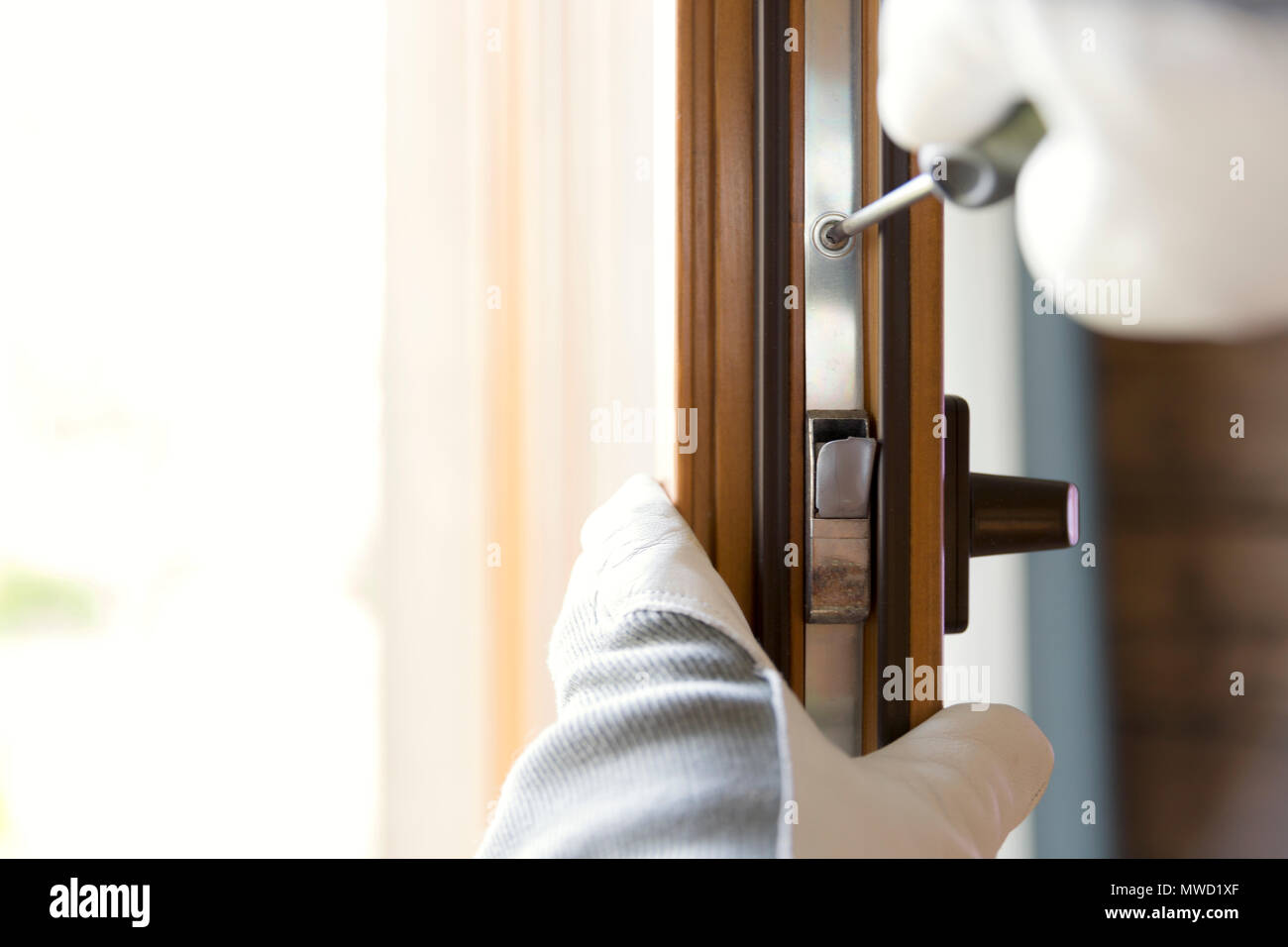 Construction worker installing window in house. Handyman fixing the ...
