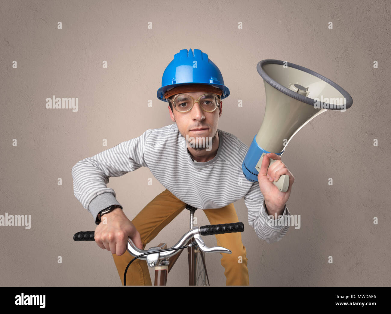 Nerd young foolish biker on a bike with oldschool outfit Stock Photo ...