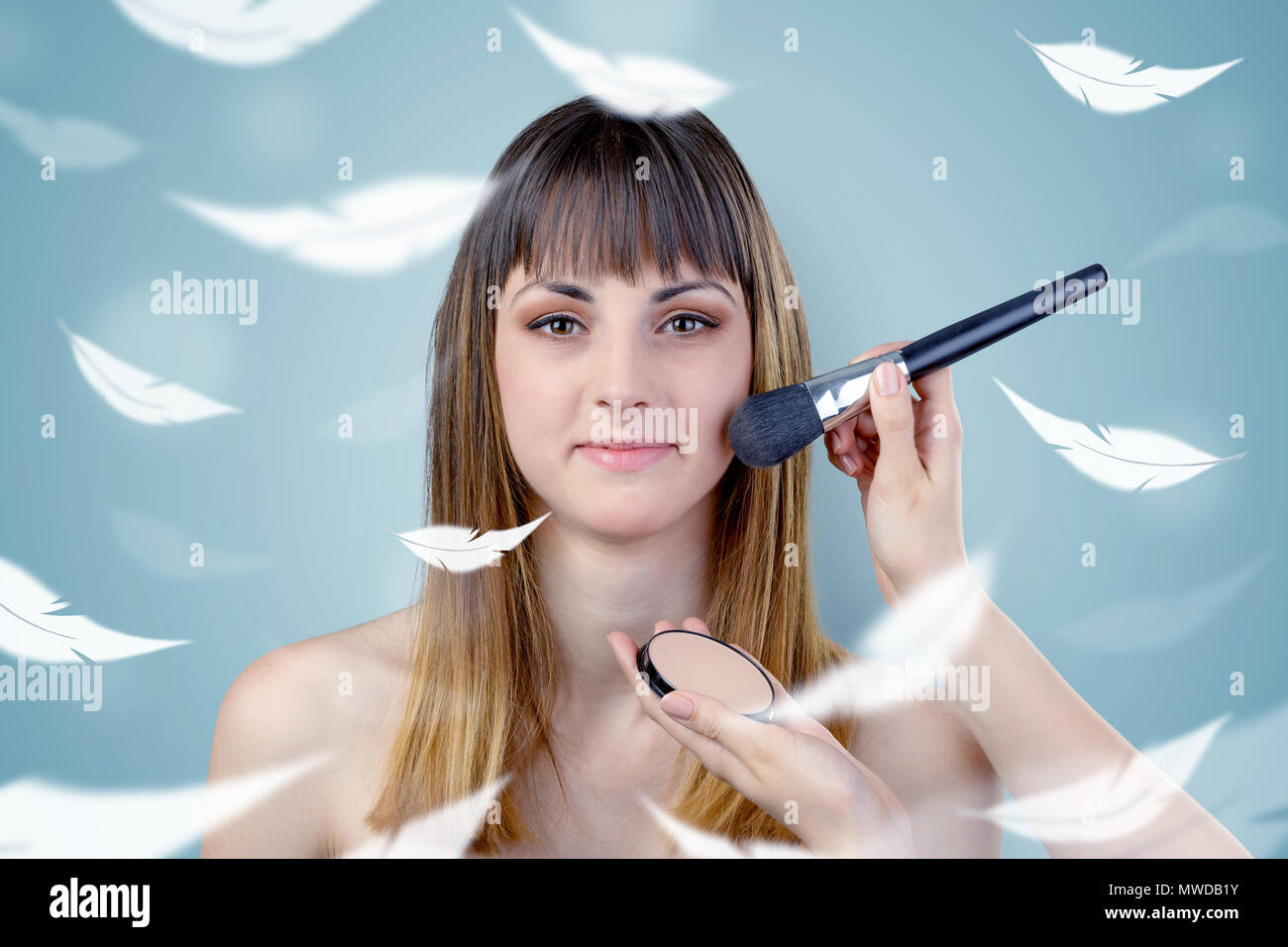 Pretty brunette woman at salon with plume around and ethereal concept ...