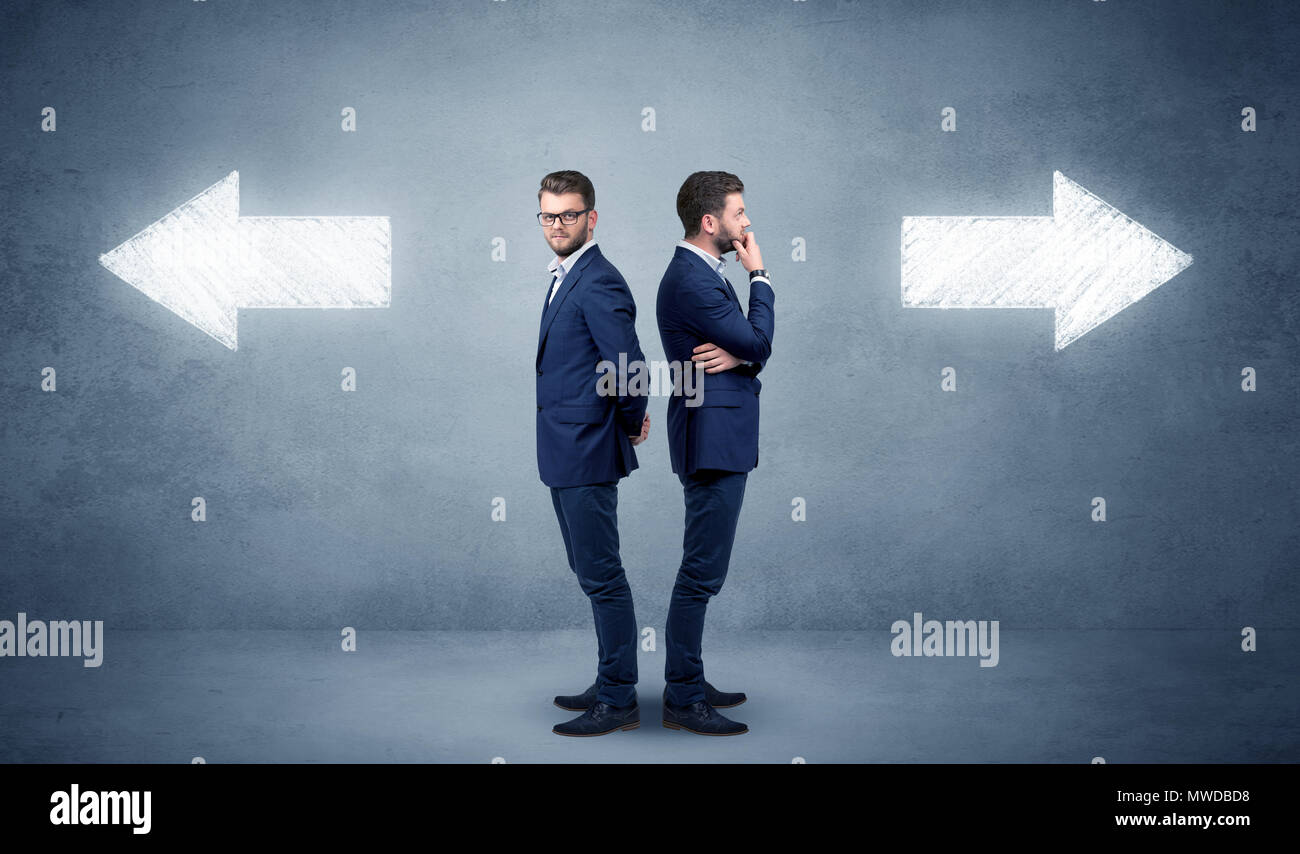 Young conflicted businessman choosing between two directions Stock ...