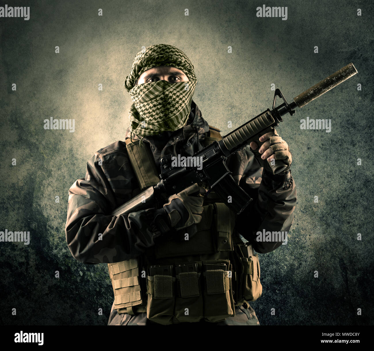 Portrait of a heavily armed masked soldier with grungy background ...