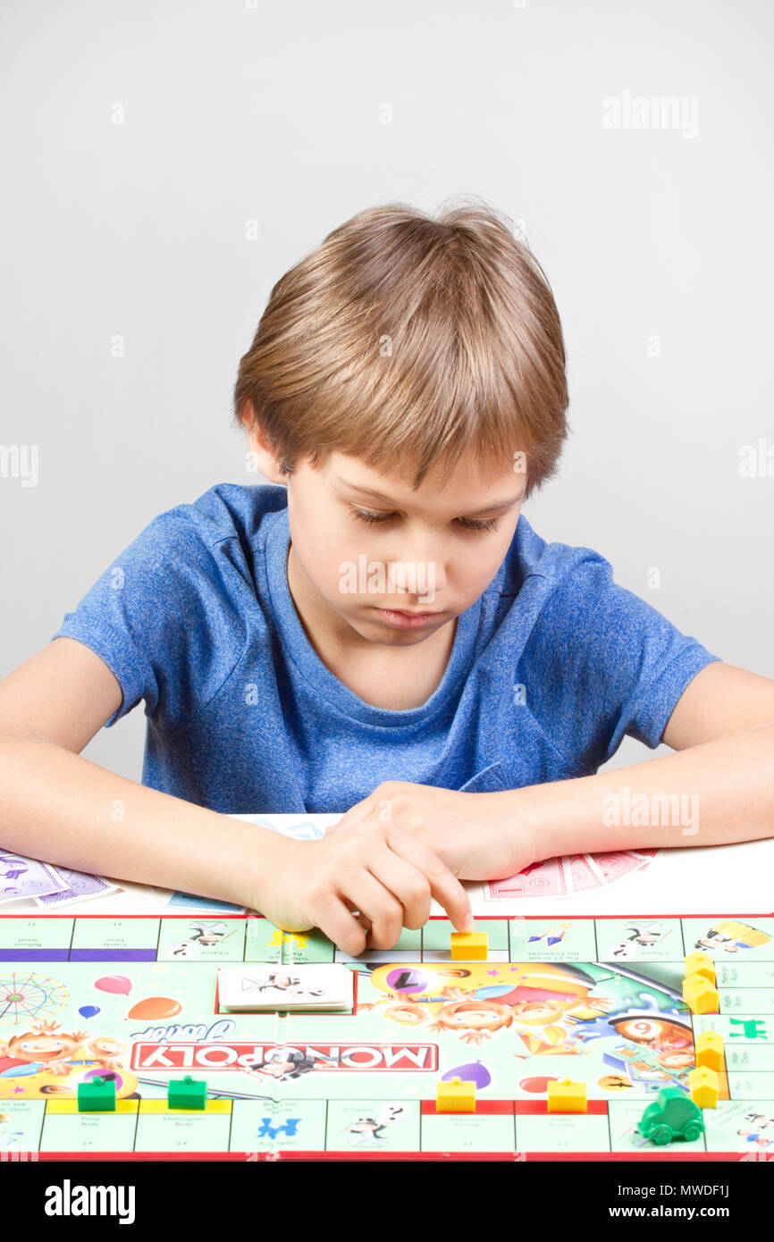 Kid playing board game Monopoly Stock Photo - Alamy