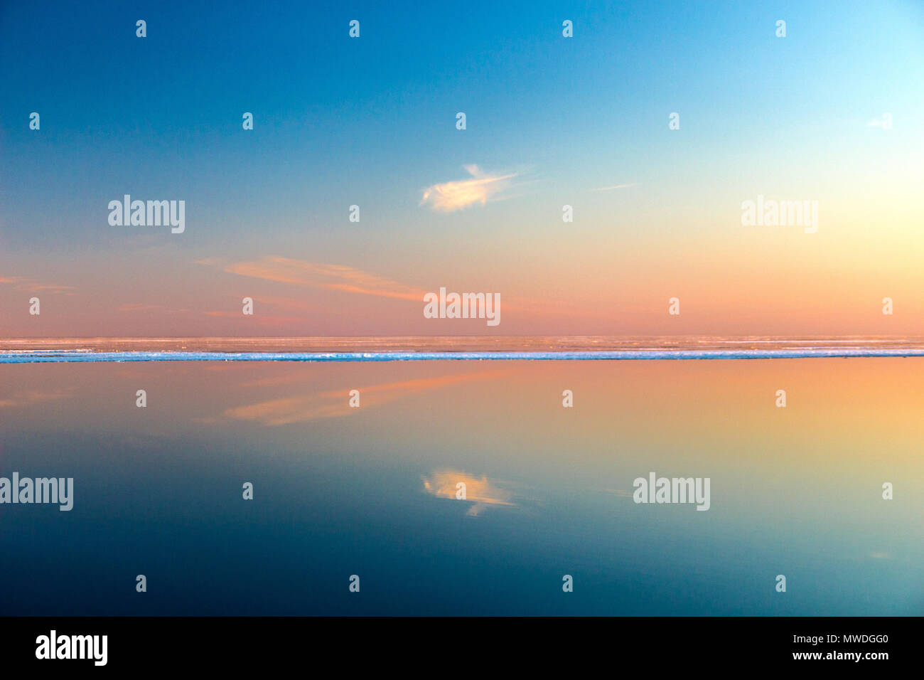 Sea surface with reflection of sky and clouds at sunset Stock Photo - Alamy