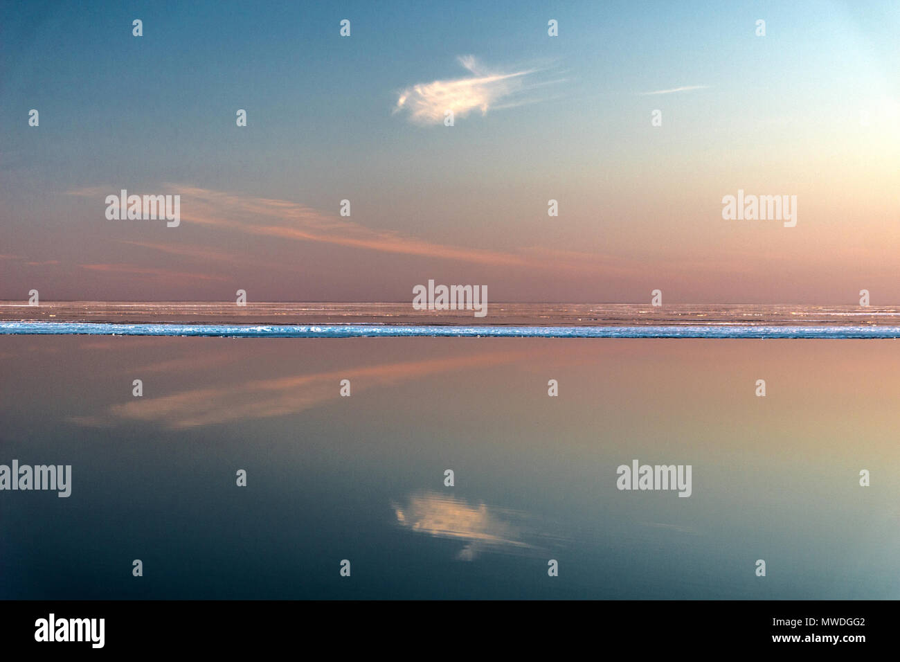 Sea surface with reflection of sky and clouds at sunset Stock Photo - Alamy