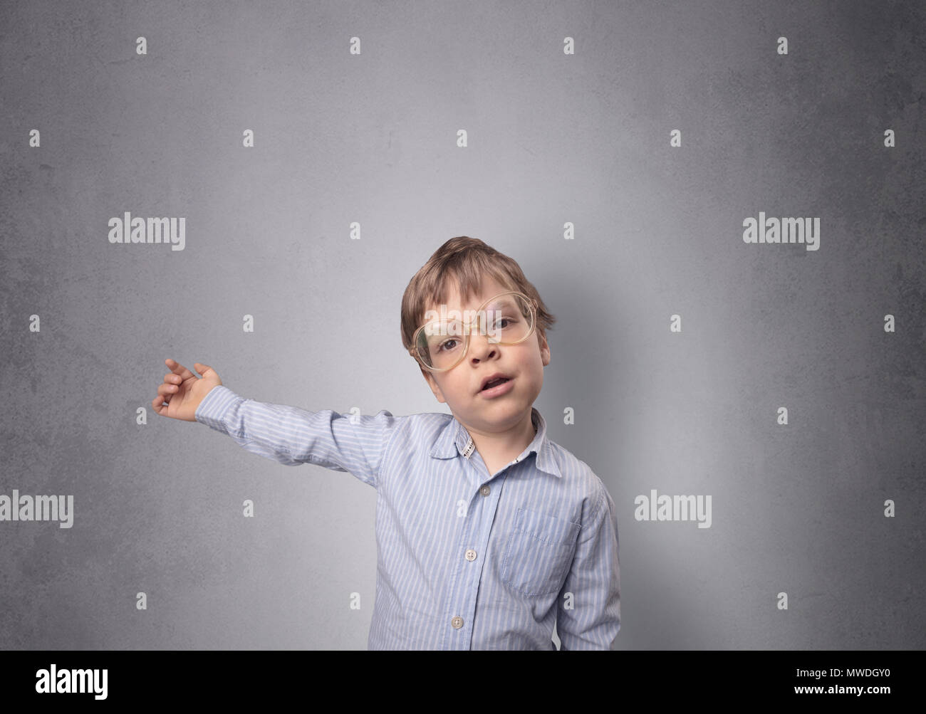 Adorable little boy portrait with empty grey wall background Stock ...