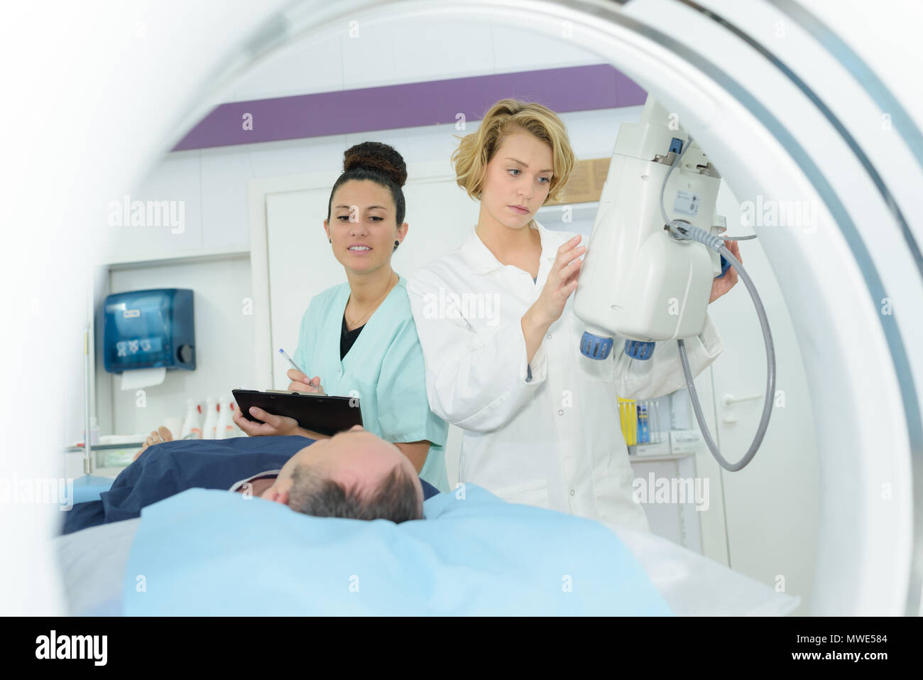 doctor assistant and patient in mri room at hospital Stock Photo - Alamy