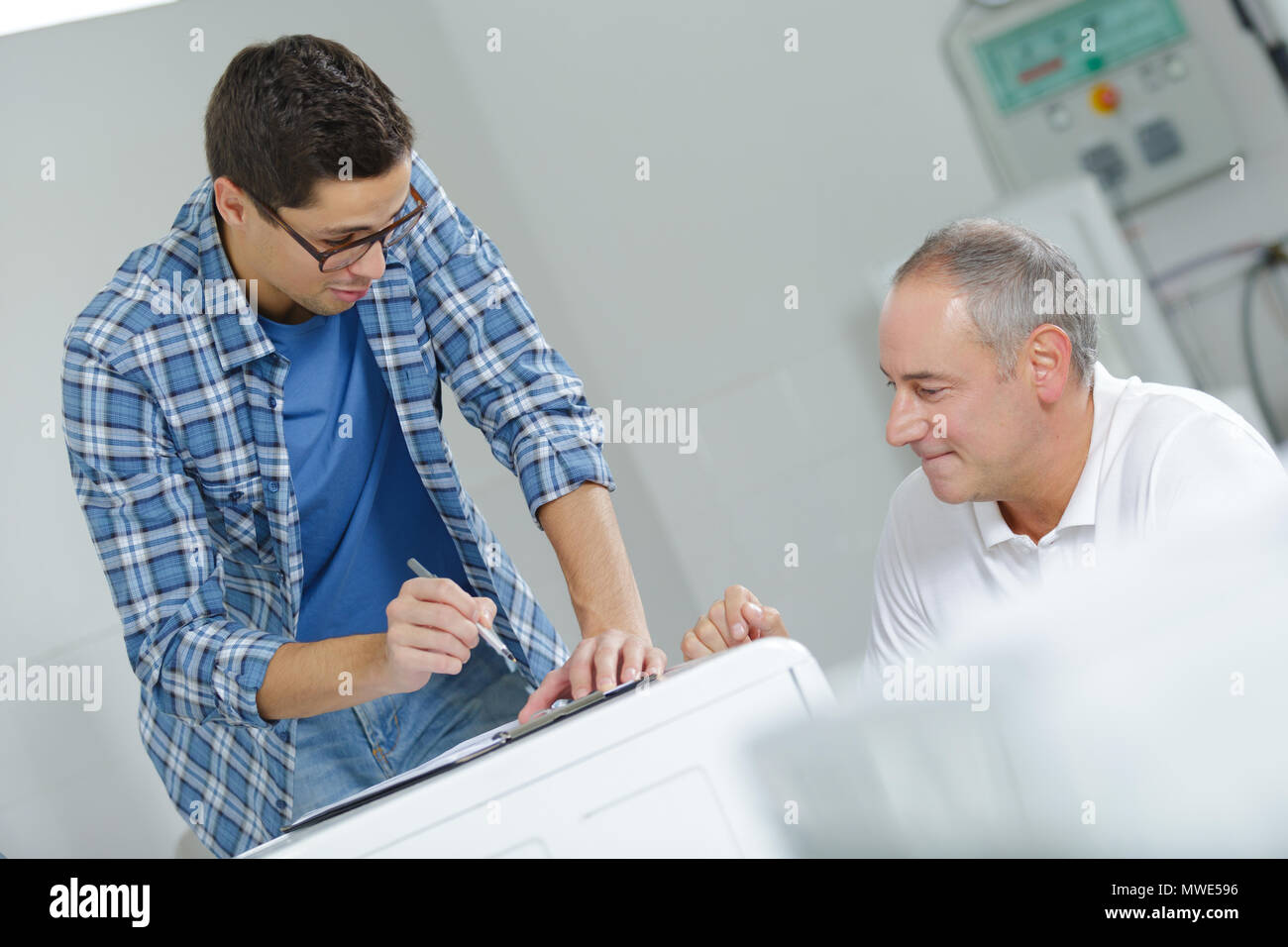 fixing a machine Stock Photo - Alamy