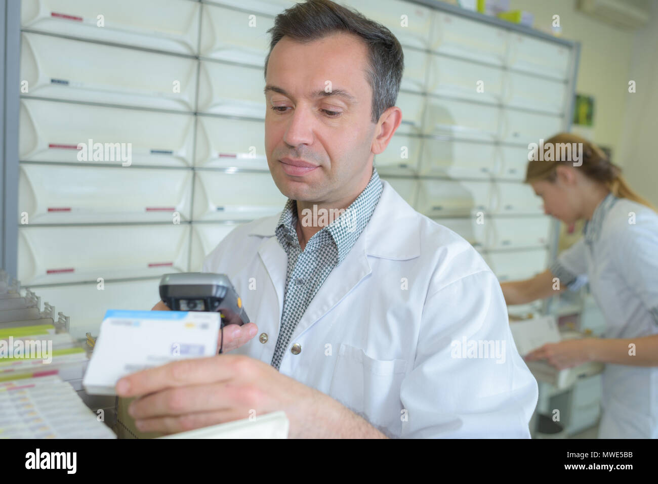 Pharmacist scanning medication Stock Photo - Alamy