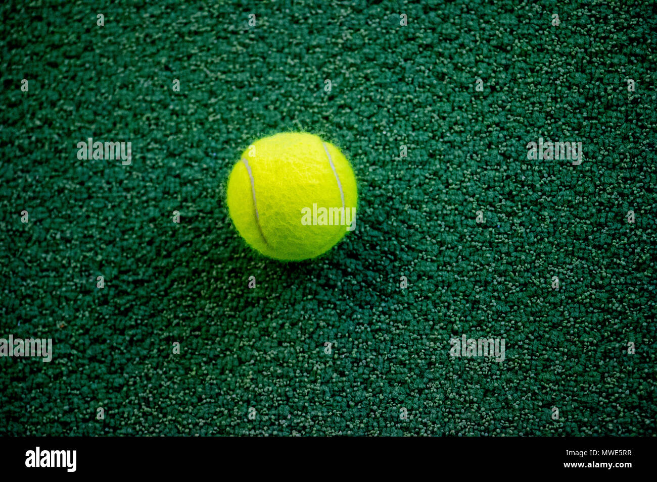 Tennis ball against fake grass texture background Stock Photo - Alamy