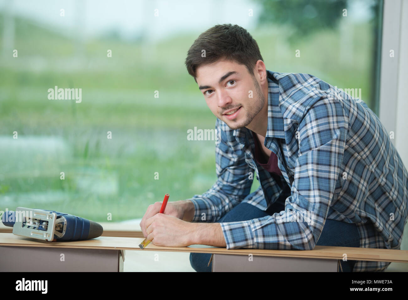 Male hands young craftsman cuts hi-res stock photography and images - Alamy