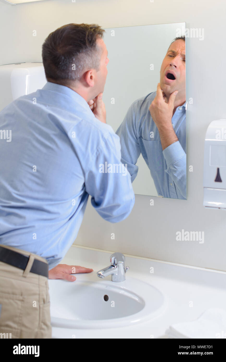 man looking in mirror Stock Photo - Alamy