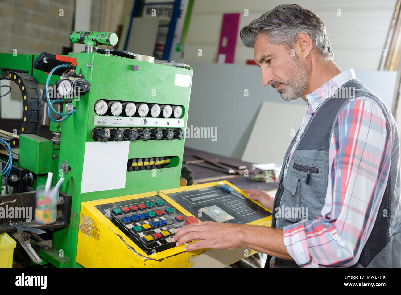 worker adjusting the machine's program Stock Photo - Alamy