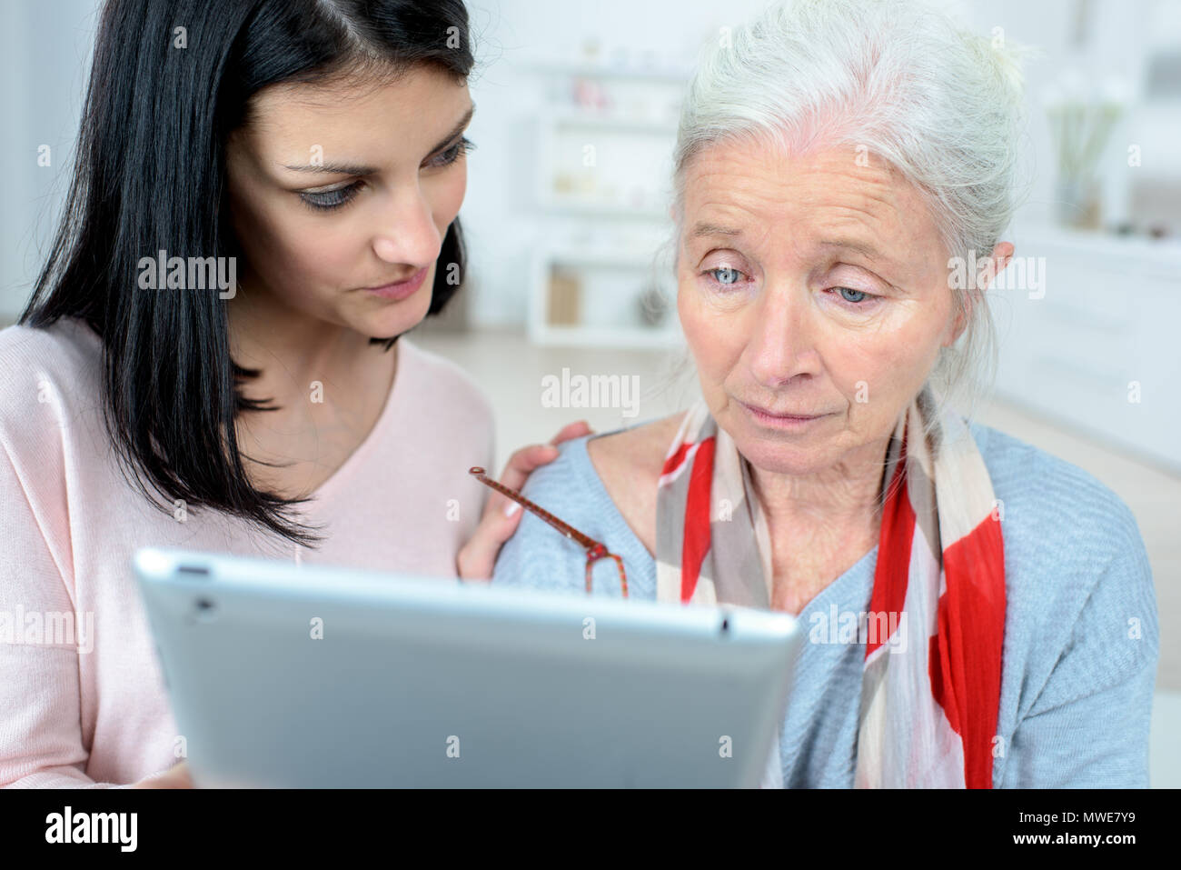 sad elderly woman after receiving an email in her tablet Stock Photo ...