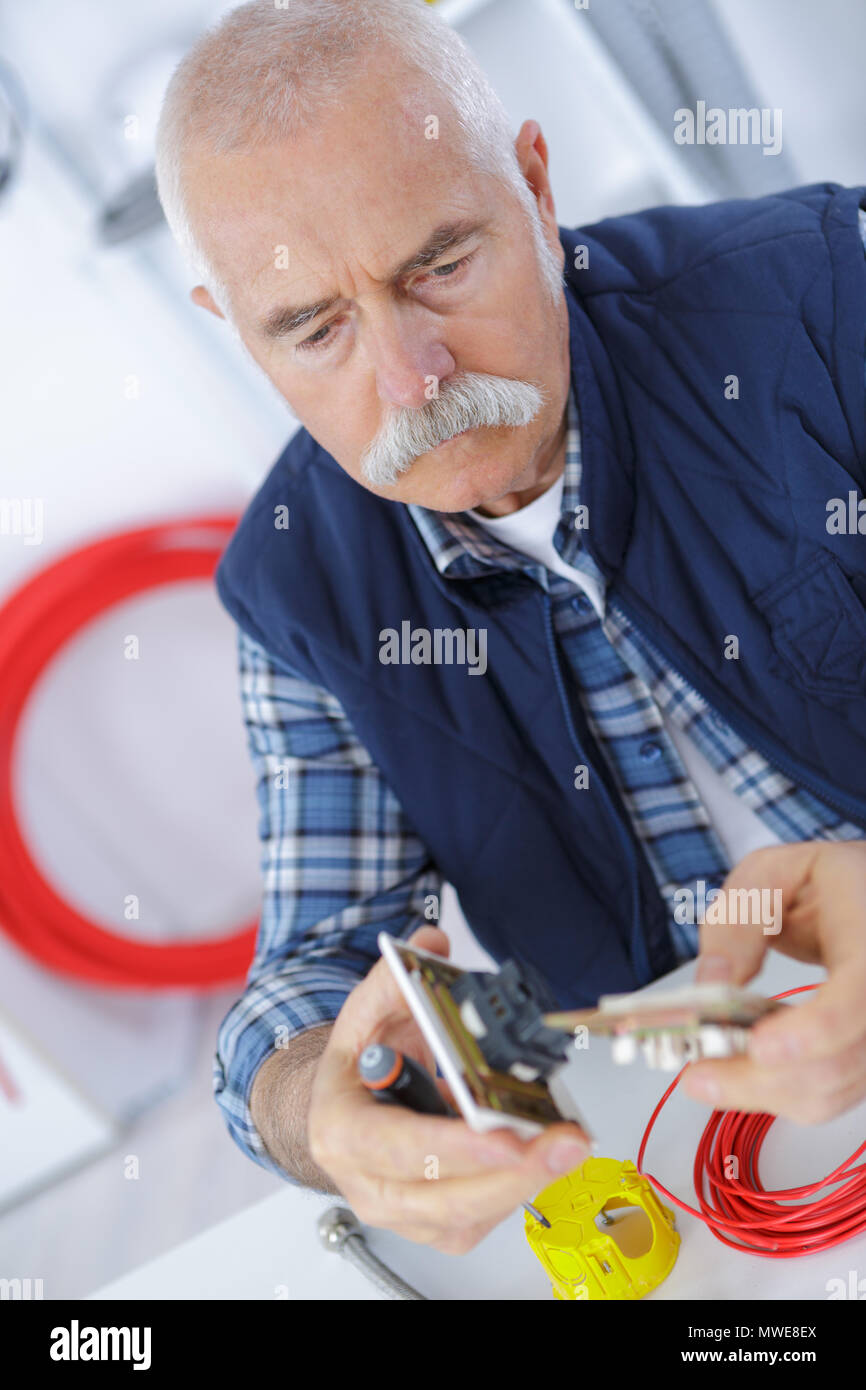 start the installation of overhead electrical outlets Stock Photo - Alamy