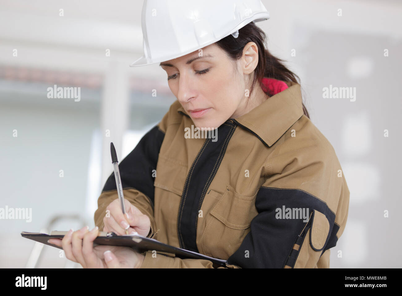 female construction worker taking notes at the construction site Stock ...
