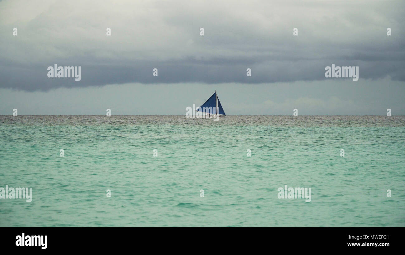 Sailing boat on sea. Sailing ship yachts with blue sails in the ocean ...