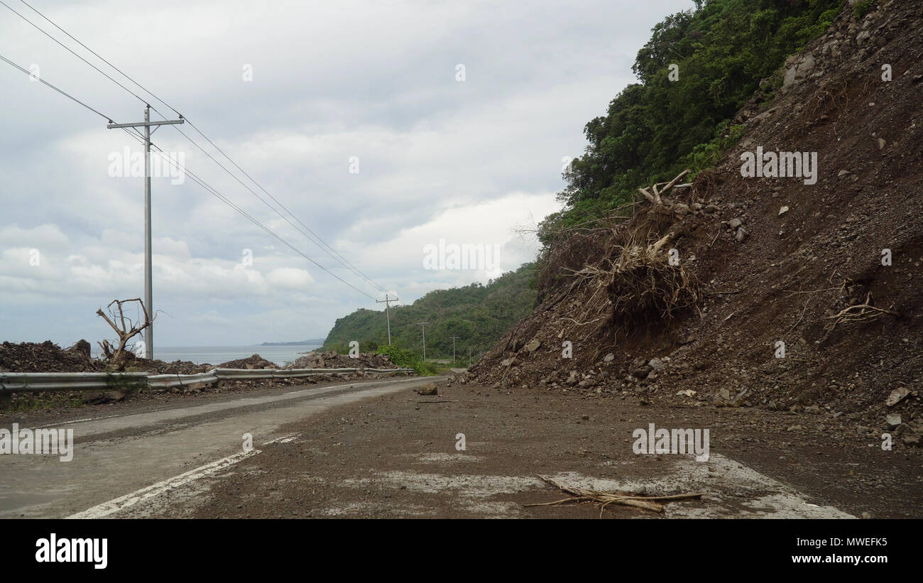 Landslides and rockfalls on the road in the mountains. Mud and rocks ...