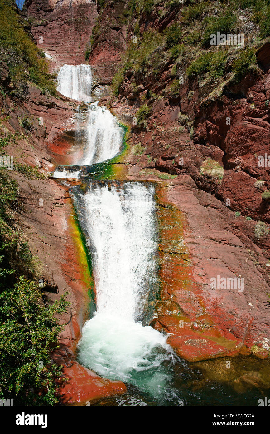 Multi-step waterfalls with plunge pools in a landscape of red rock ...