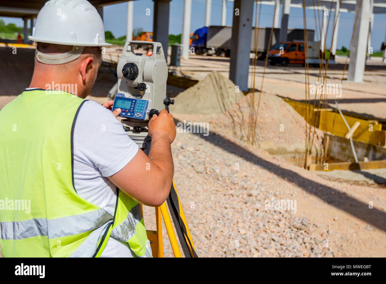 Surveyor engineer is measuring level on construction site. Surveyors ...