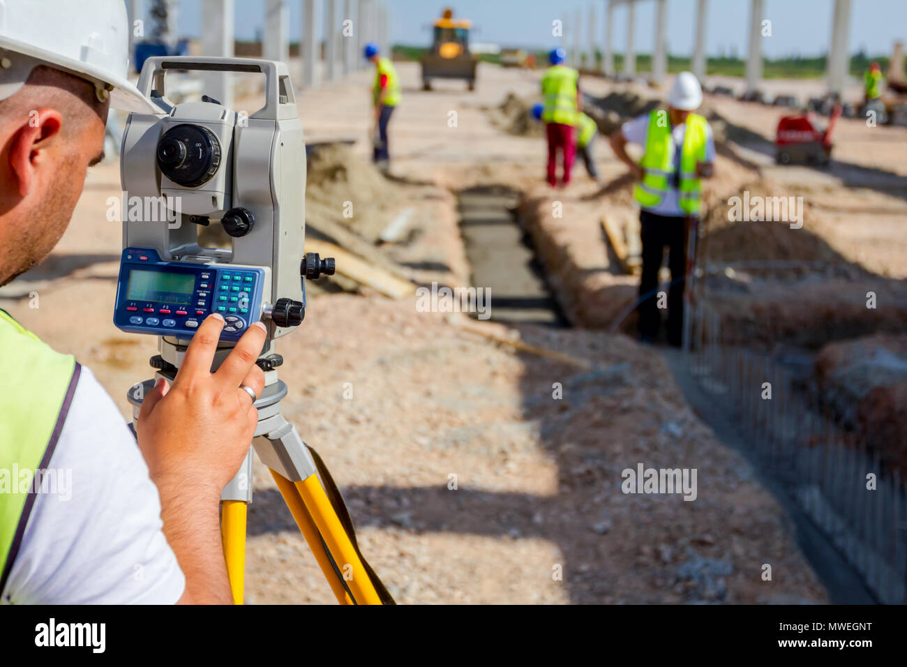 Surveyor engineer is measuring level on construction site. Surveyors ...