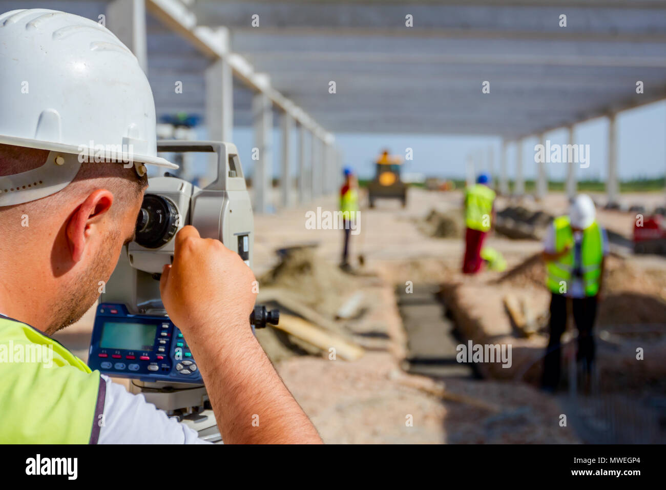 Surveyor engineer is measuring level on construction site. Surveyors ...