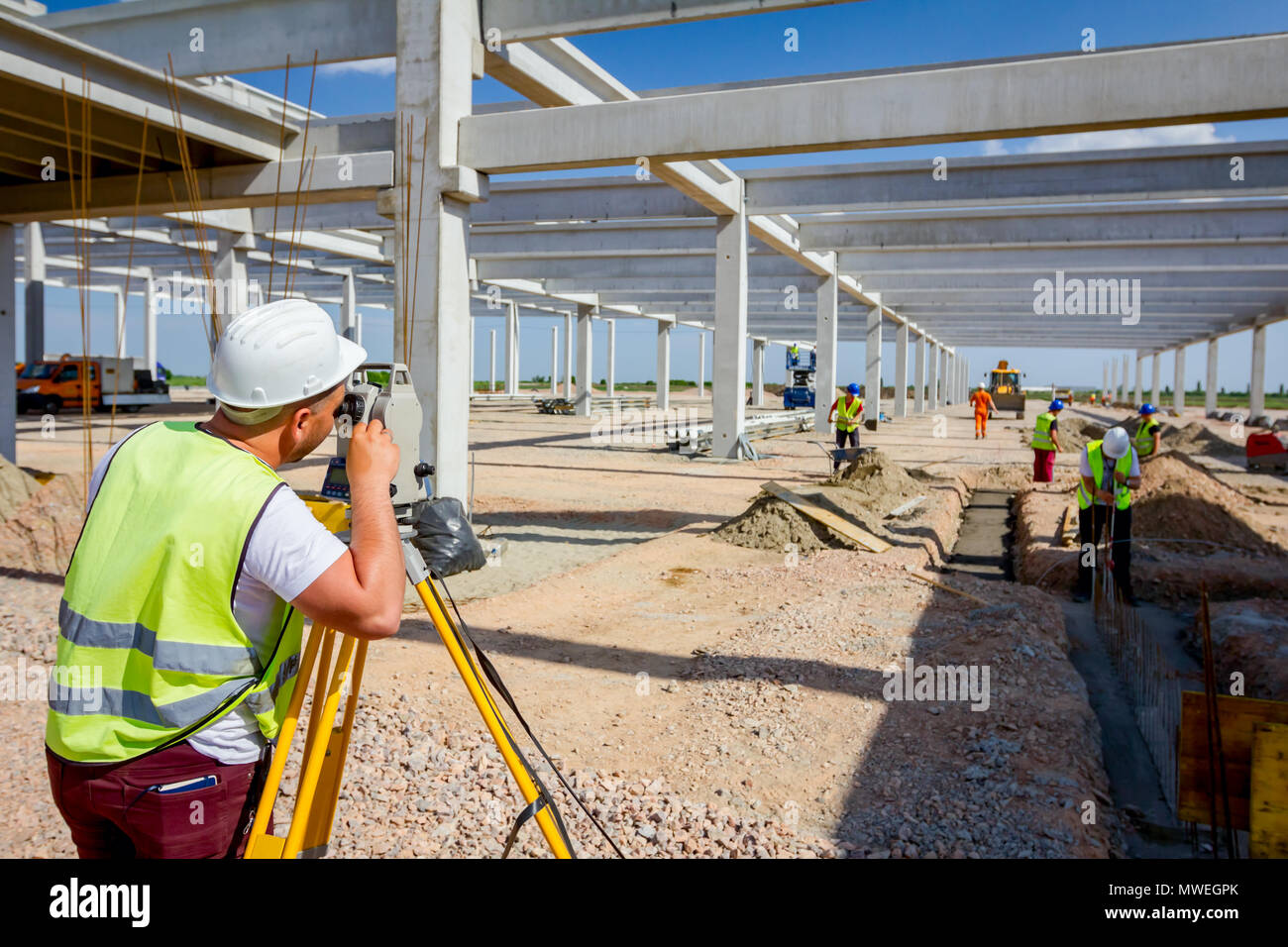 Surveyor engineer is measuring level on construction site. Surveyors ...