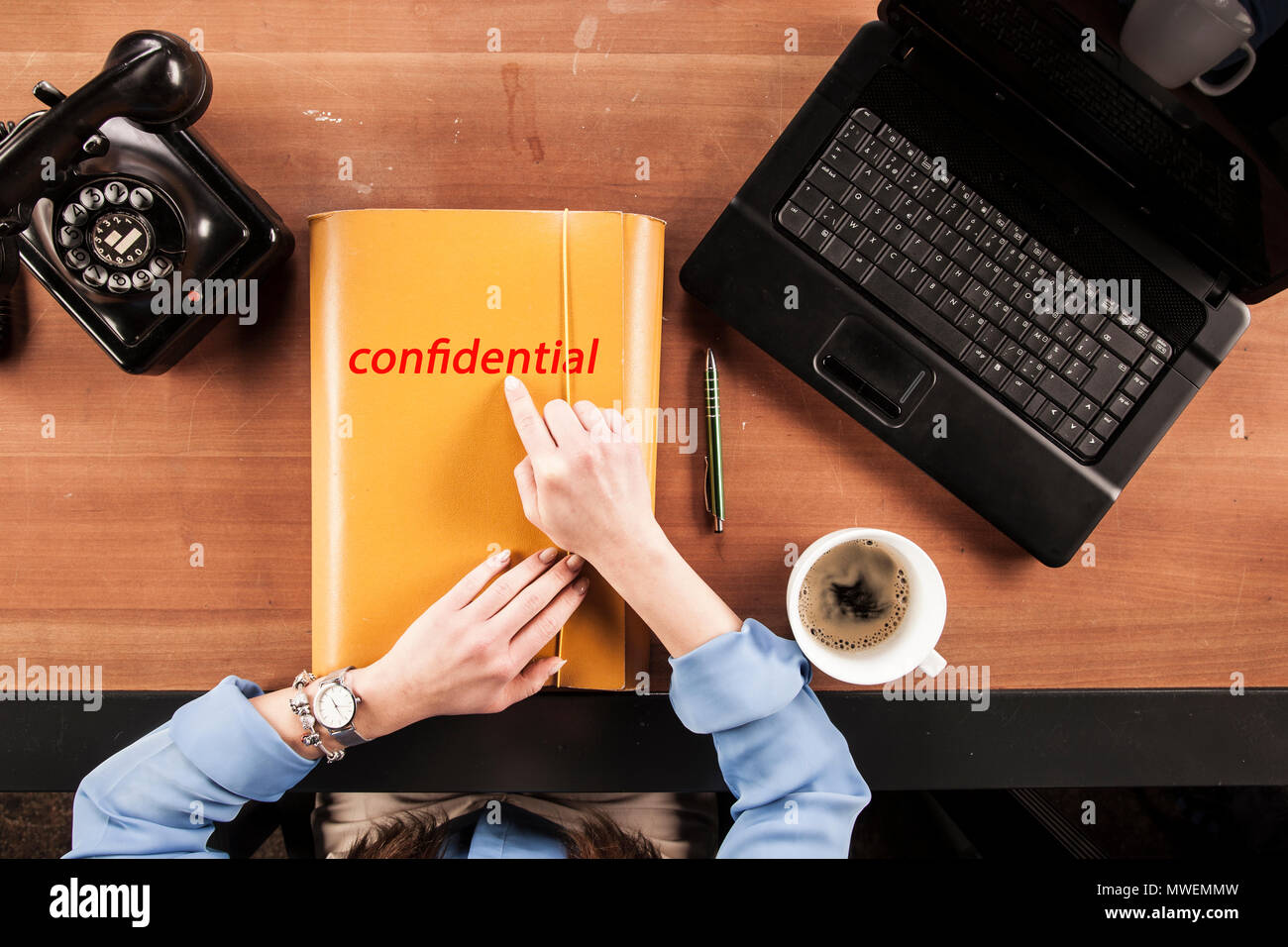 secretary keeps confidential documents on her desk, view from above ...