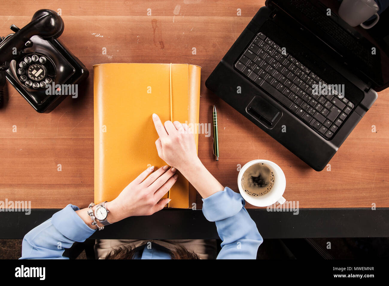 secretary holds confidential documents on the desk, view from above ...