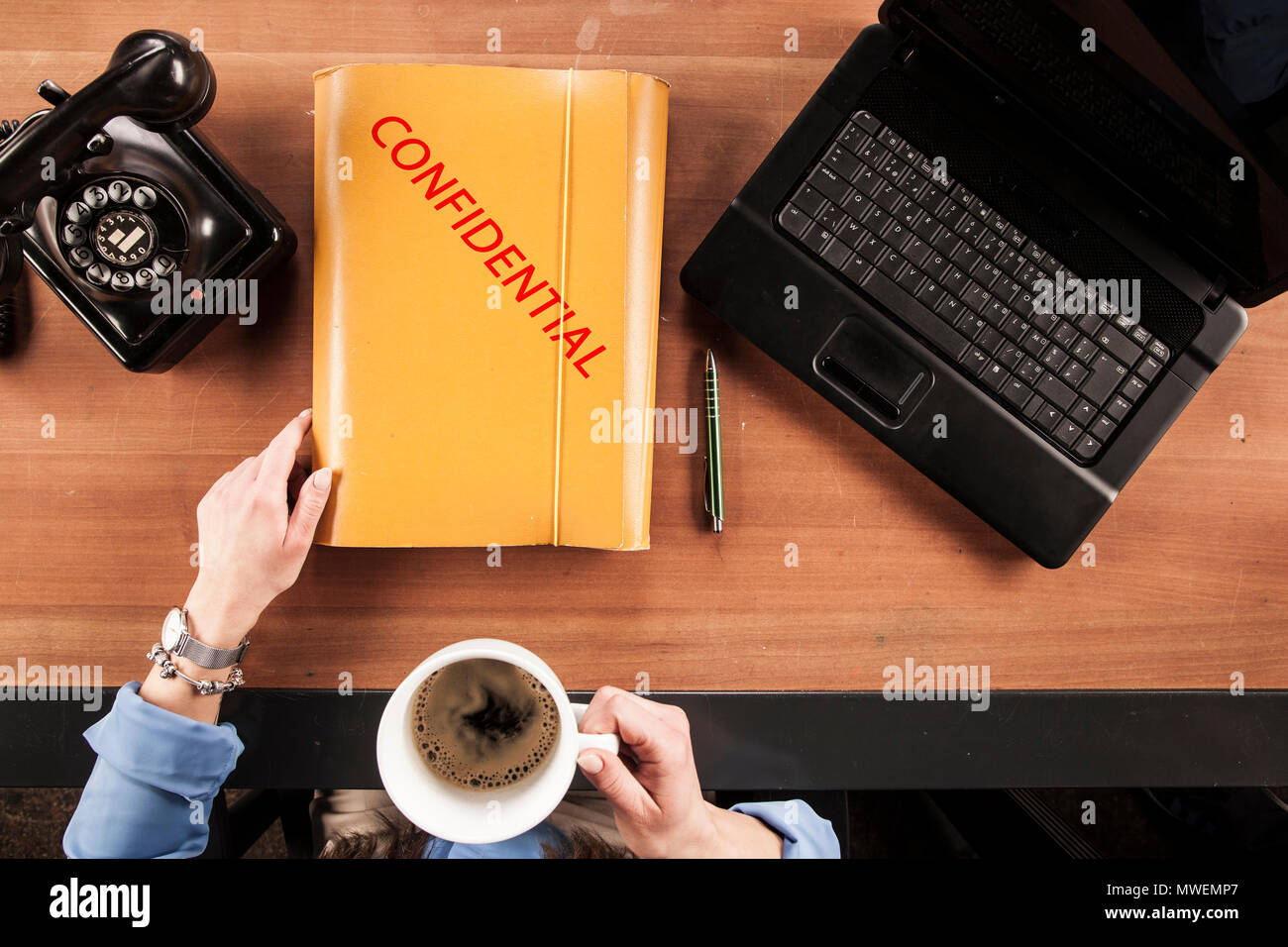 secretary holding confidential documents, view from above on the desk ...