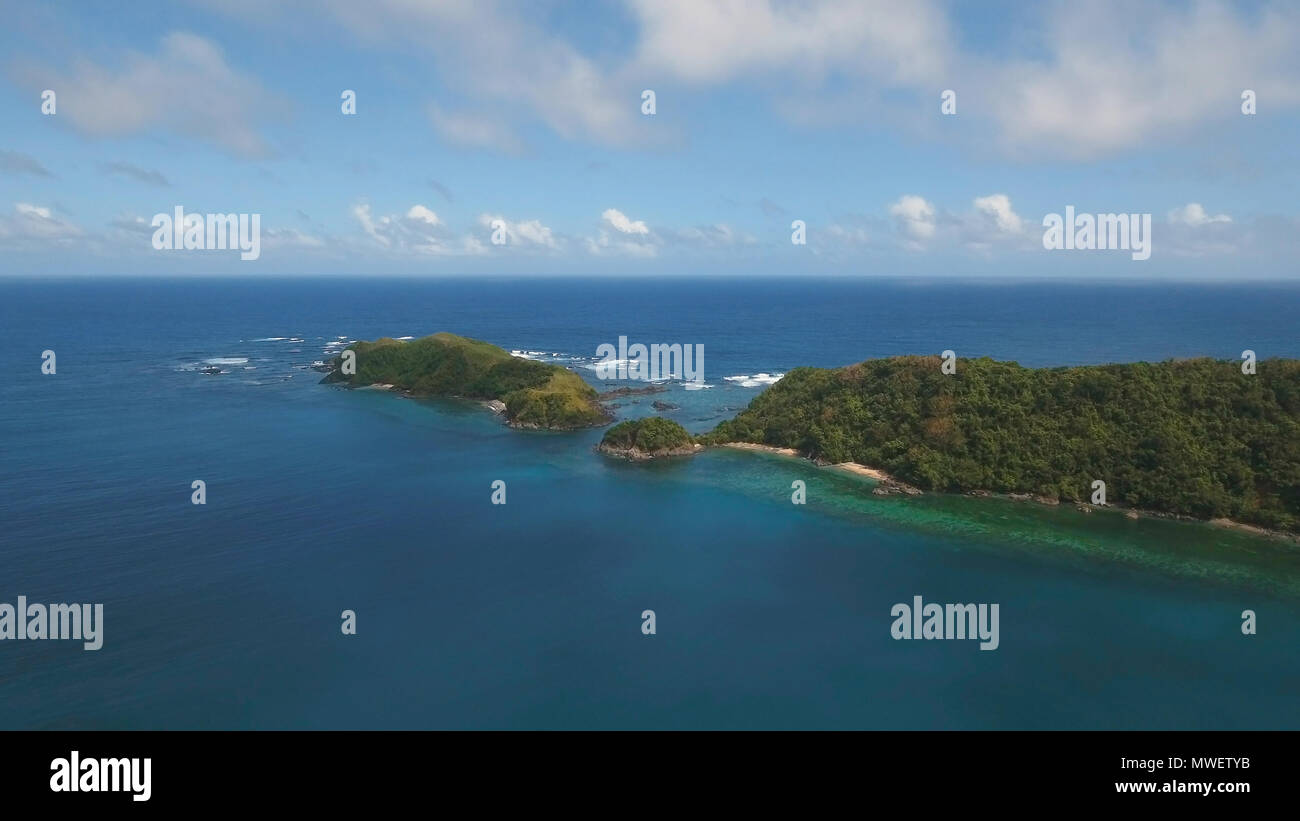 Aerial view:Tropical island with beach, mountains and the rainforest ...